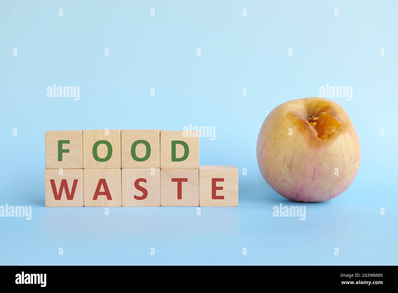 Food waste concept. Fruit and vegetable scrap with wooden blocks ...