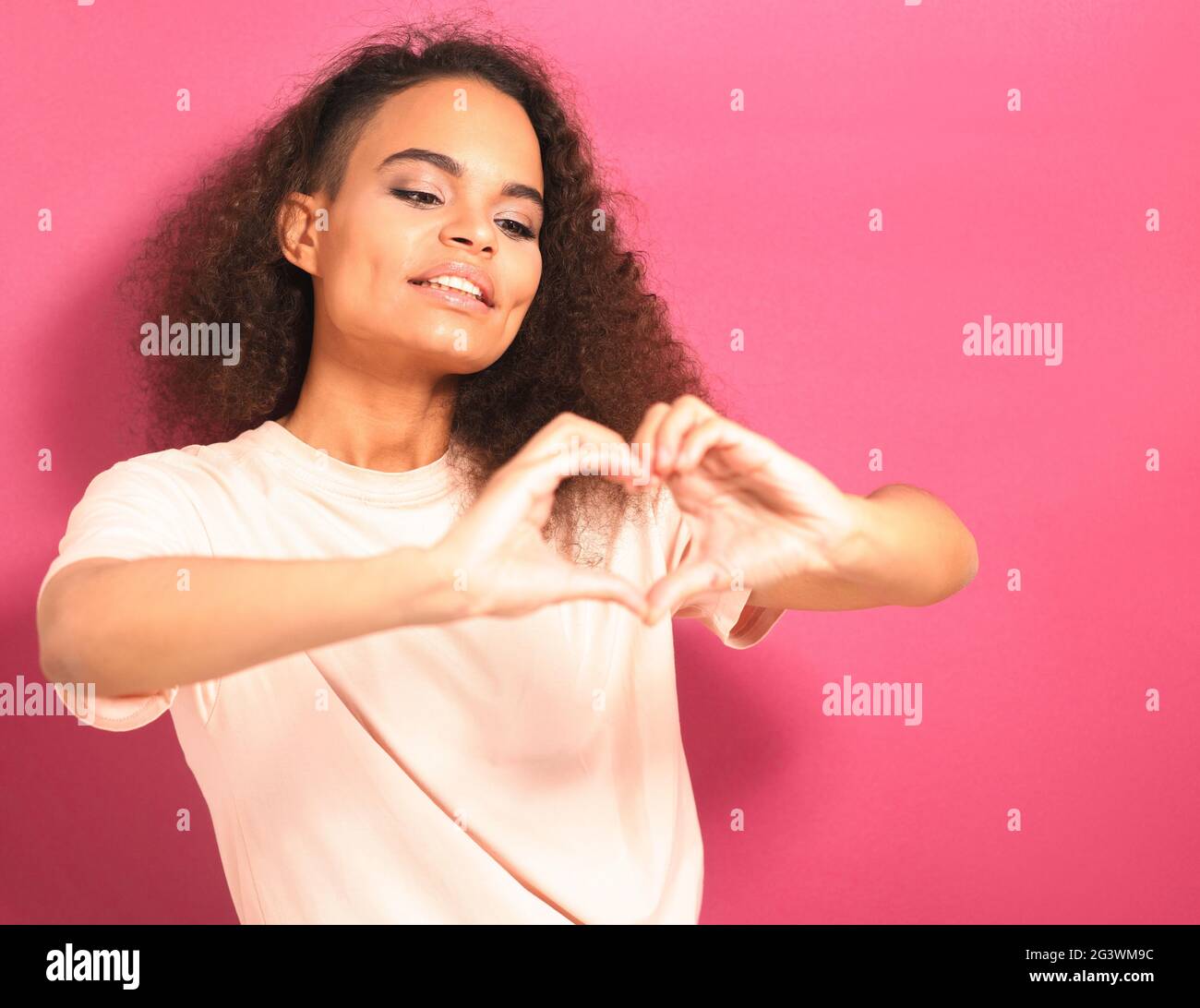 Sending love with gesture of a tender looking beautiful young African ...