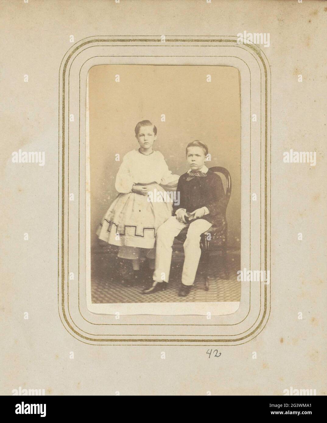 Portrait of a boy and a girl. Part of family album from H.W.F ...