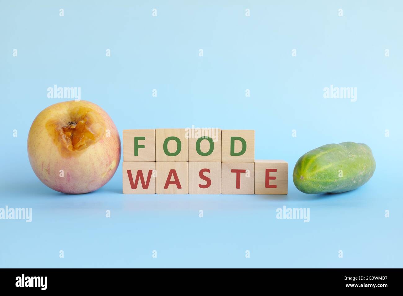 Food waste concept. Fruit and vegetable scrap with wooden blocks ...