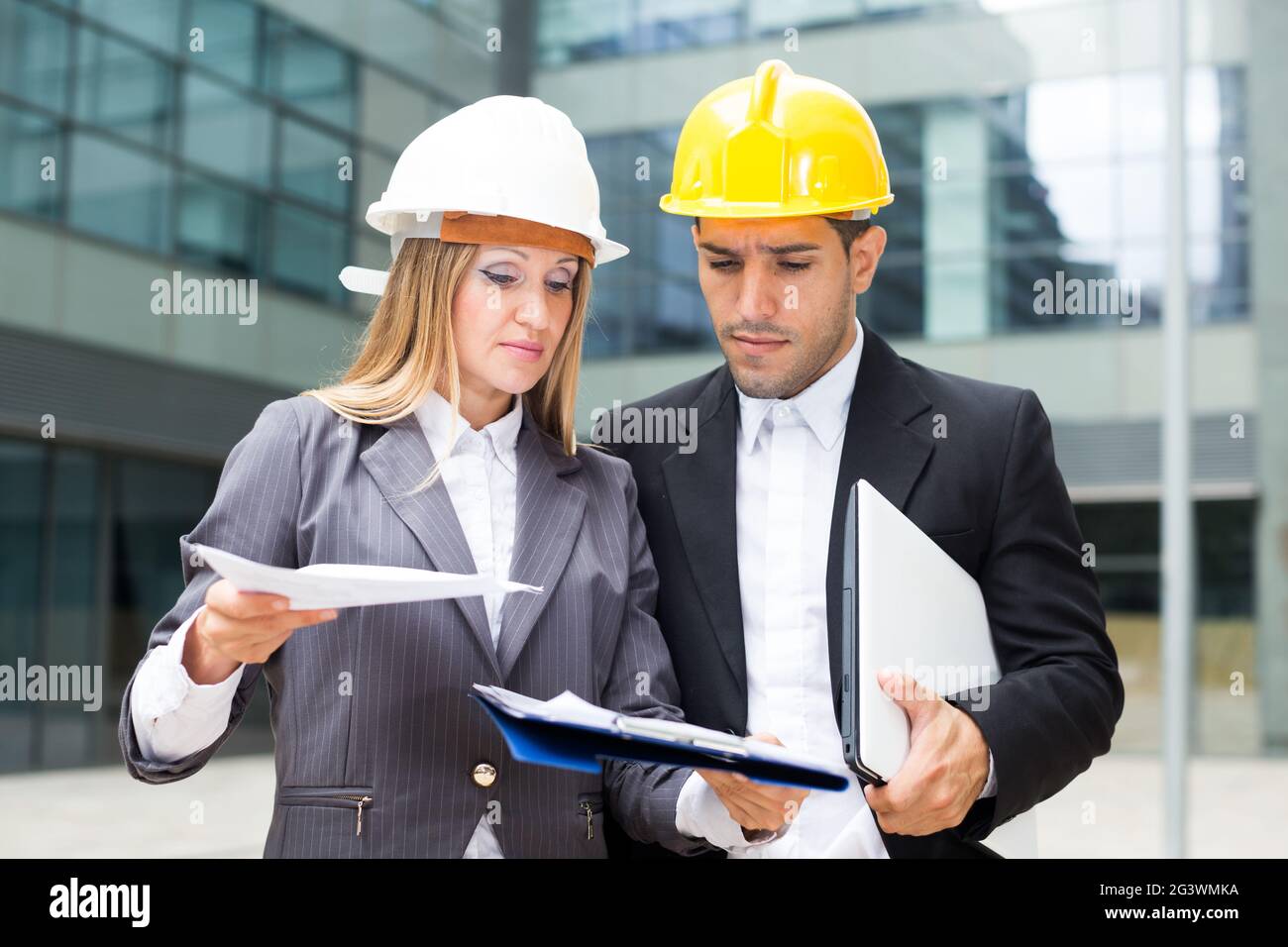 Smiling engineer and woman designer are estimating results of their project Stock Photo - Alamy