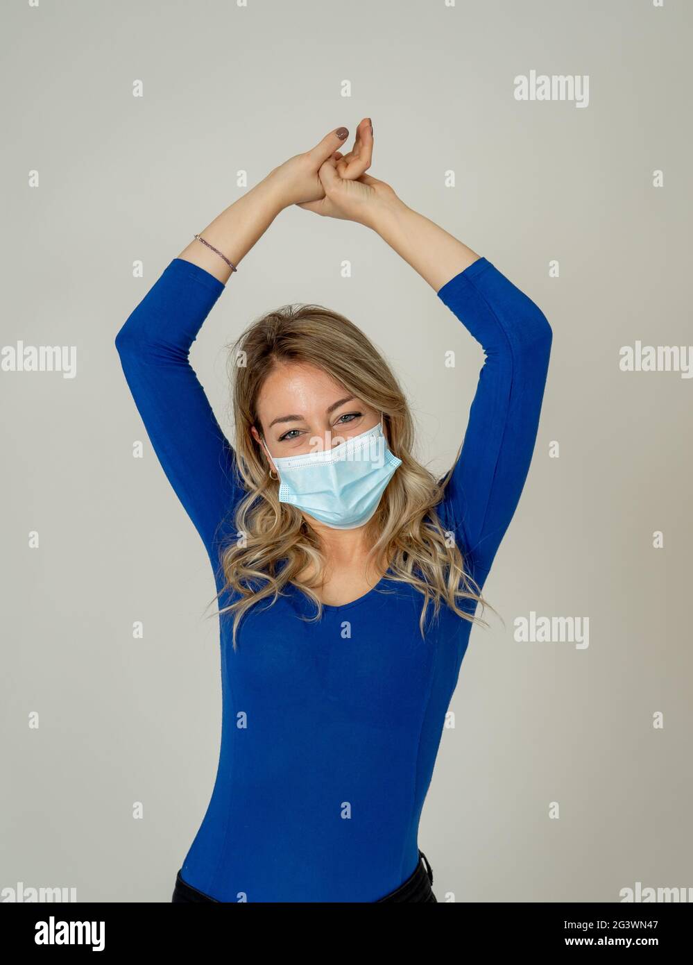 Close-up portrait of young attractive woman wearing protective medical ...