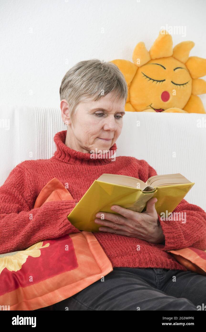 Reading in red Stock Photo - Alamy