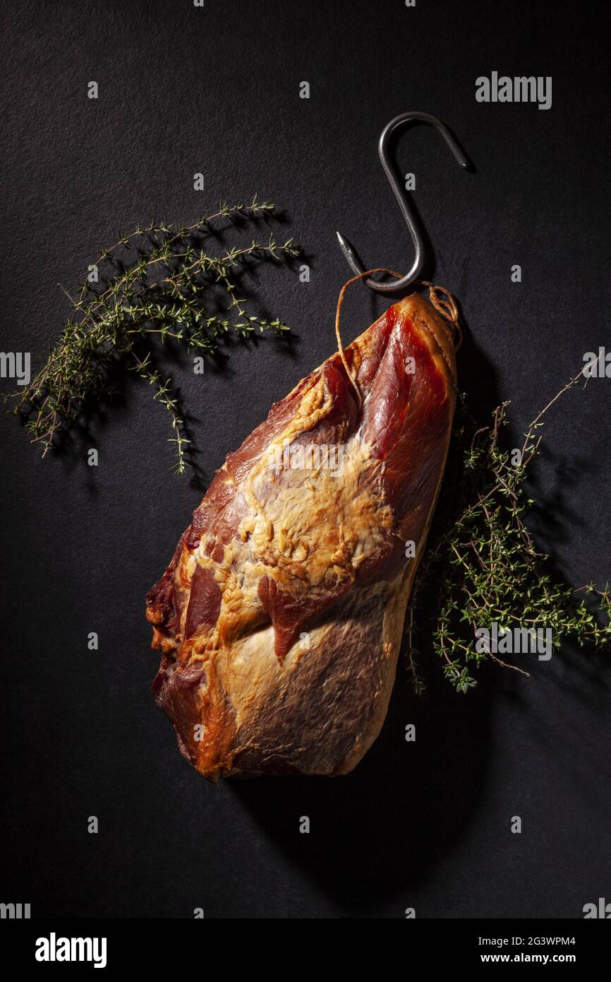 Smoked meat on black background with fresh aromatic herbs Stock Photo ...