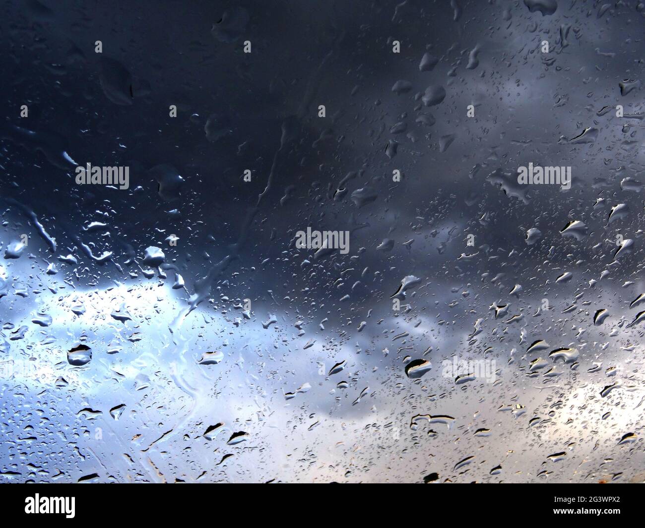 Rainy Clouds Through Car Windshield With Drops Stock Photo - Alamy