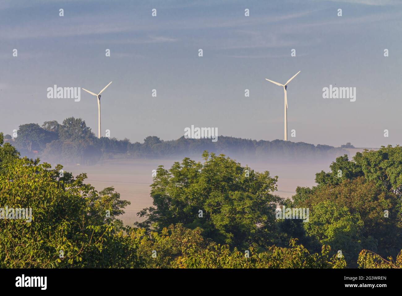 Wind turbines in the morning mist Stock Photo - Alamy