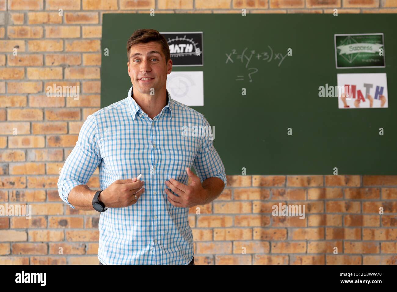 Portrait of male caucasian teacher teaching mathematics in the ...