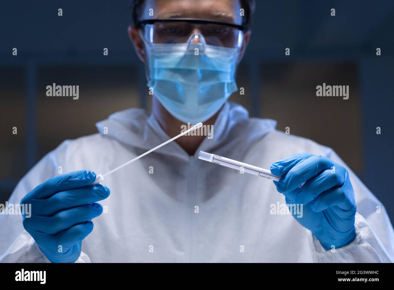 Caucasian male medical worker wearing protective clothing and face mask ...