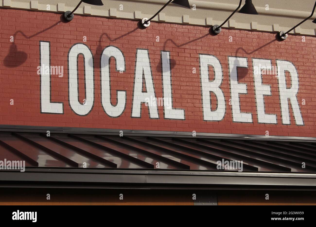 Local Beer Sign on Brick Wall Stock Photo - Alamy