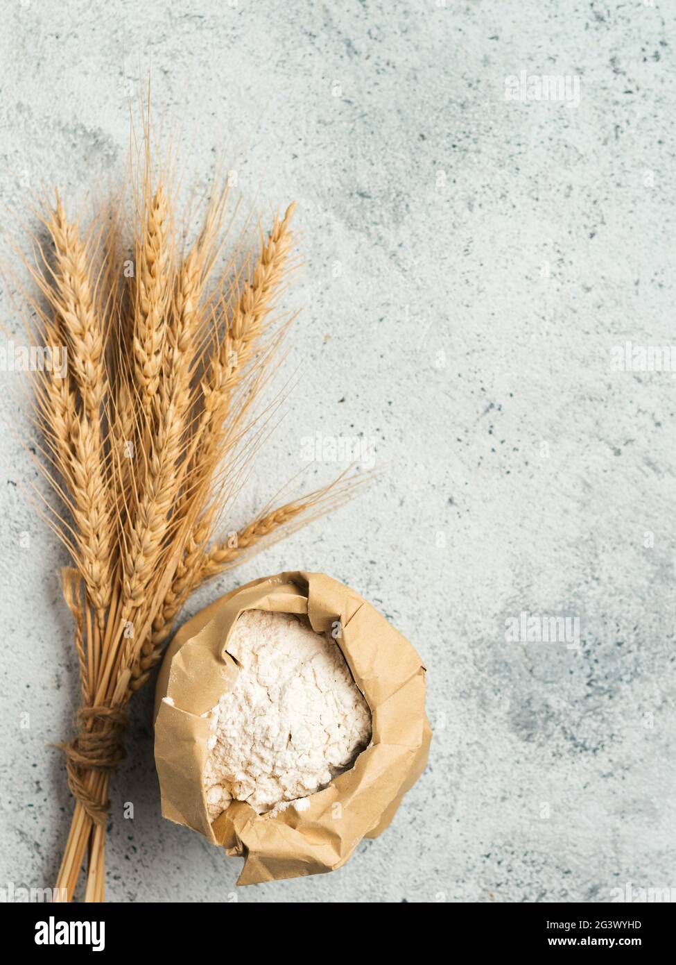 Wheat flour in paper bag on gray cement background Stock Photo - Alamy