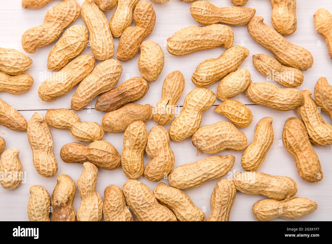 Background from peanuts nuts. Peanuts in shells and clean kernels. Top ...