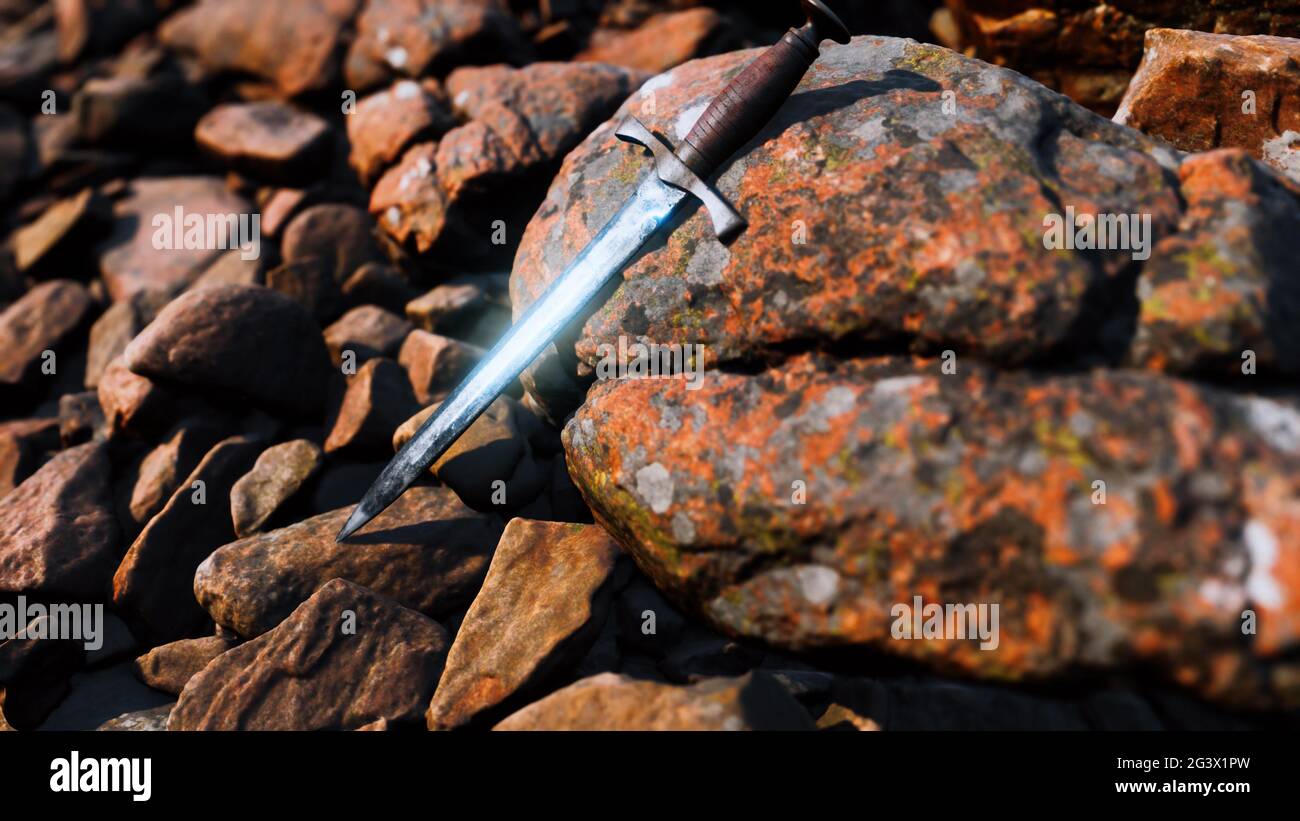 Old dagger on the rock at sunset Stock Photo - Alamy