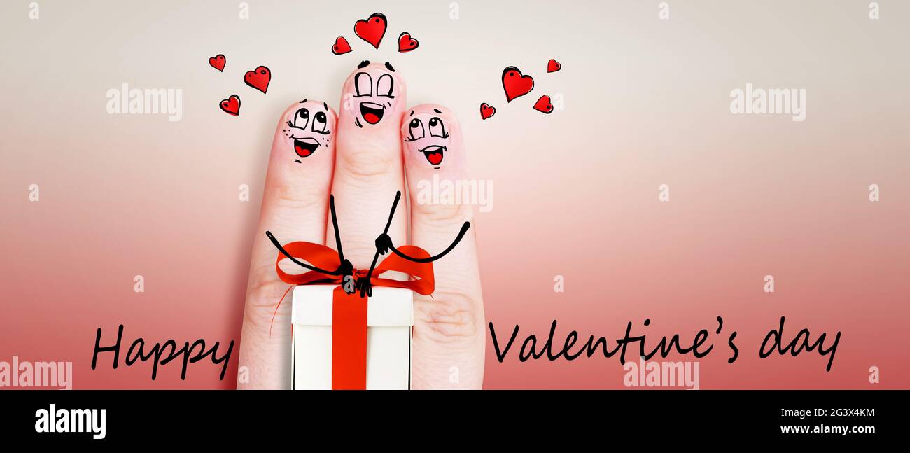 Finger puppets of loving parents with young child hugging and having ...