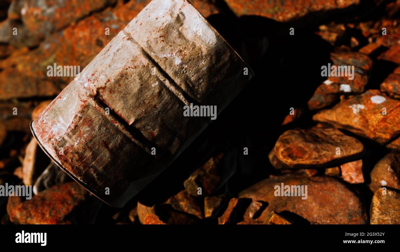 Rusty destroyed metal barrel on beach rocks Stock Photo - Alamy