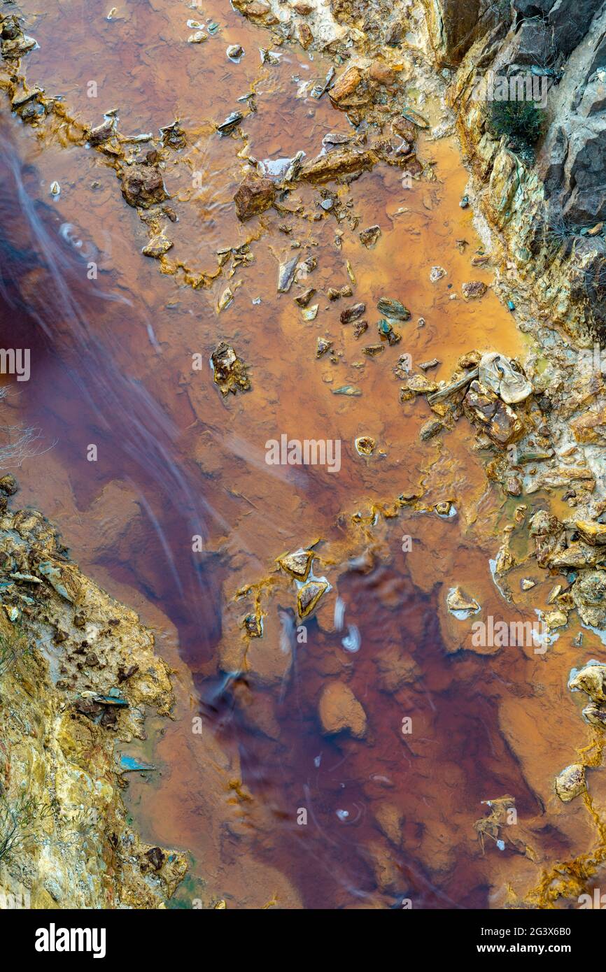 A top down abstract view of a riverbed in an abandoned mining area with ...