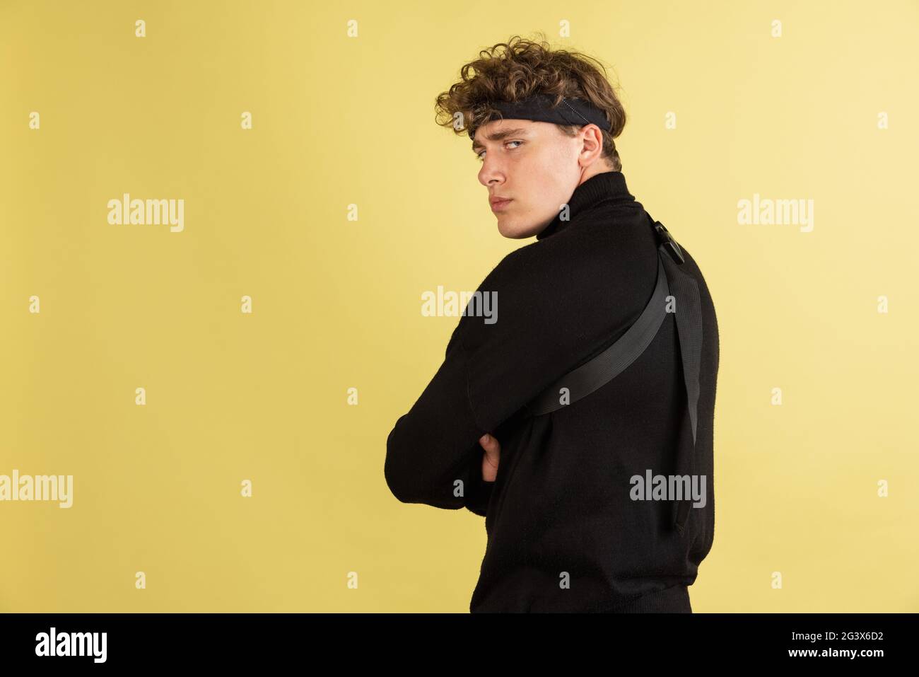 Portrait of sad resentful young man in standing and looking at camera ...