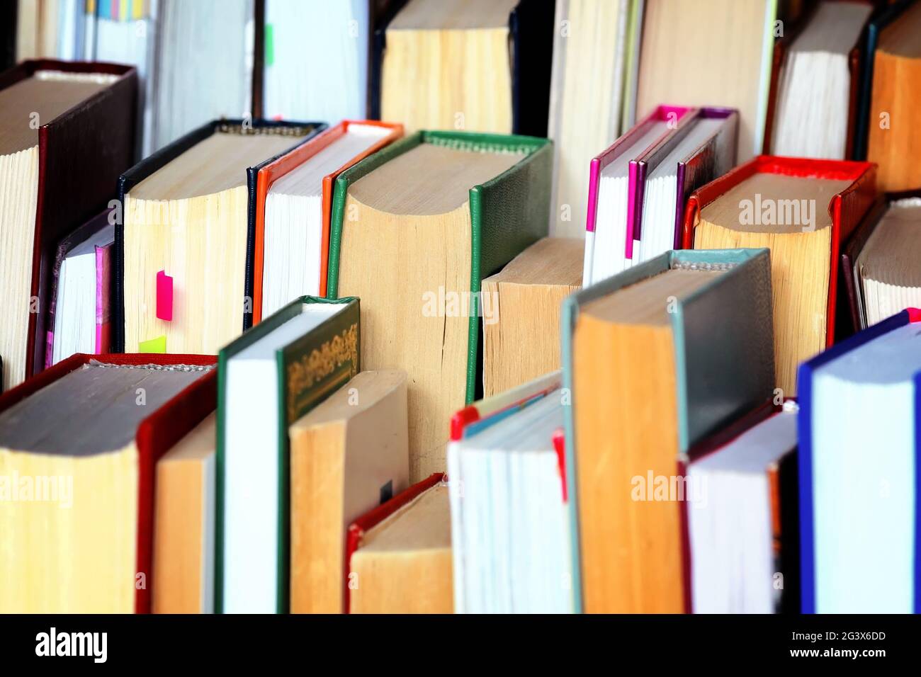This is a lot of books standing together in several rows. Solid ...
