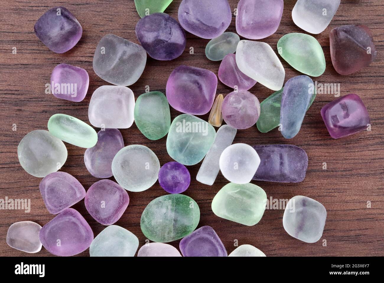 Fluorite heap up jewel stones texture on brown varnished wood ...