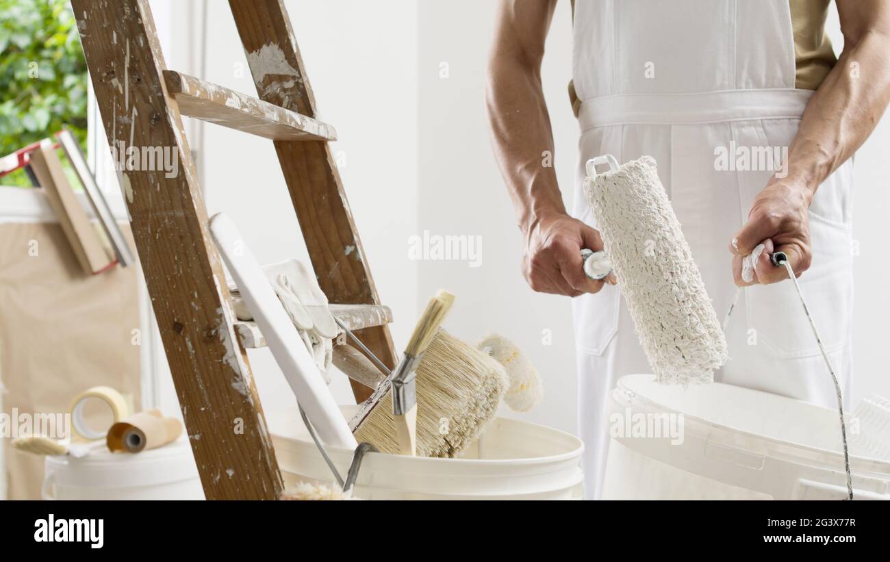 hands of house painter man decorator work of home to renovate, using ...