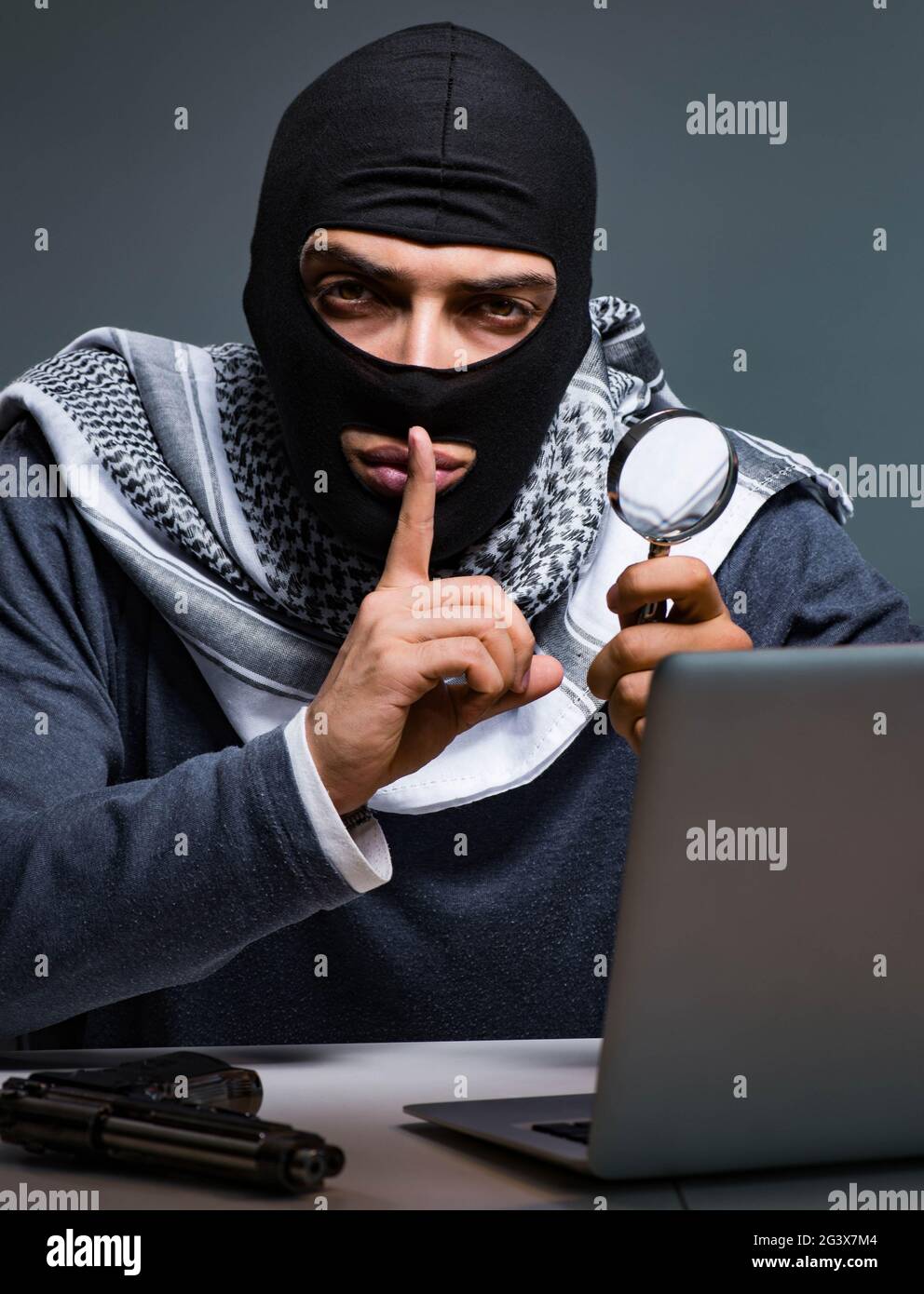 Hacker wearing balaclava mask hacking computer Stock Photo - Alamy