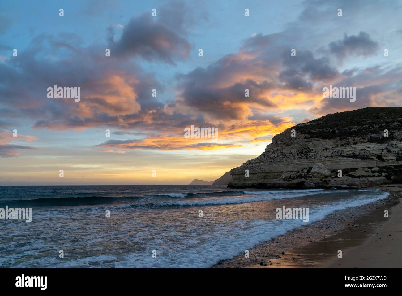 A beautiful ocean sunset on the Costa del Sol in Spain with beach and ...