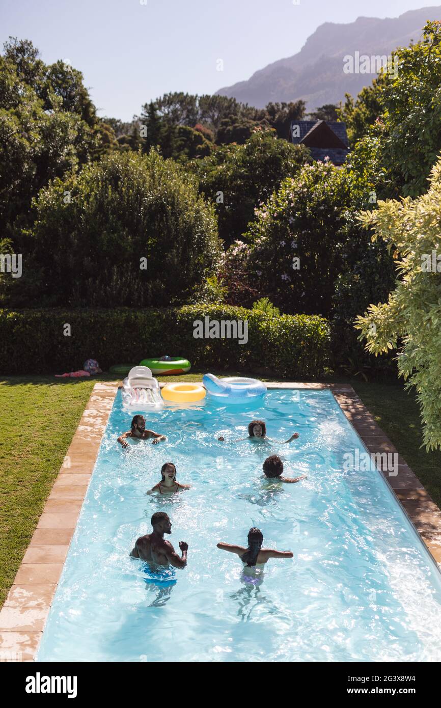 Diverse group of friends having fun in swimming pool Stock Photo - Alamy