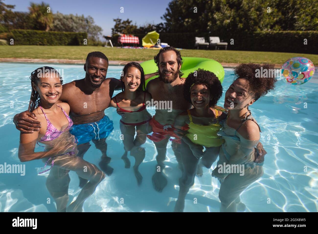 Portrait of diverse group of friends having fun in swimming pool Stock ...