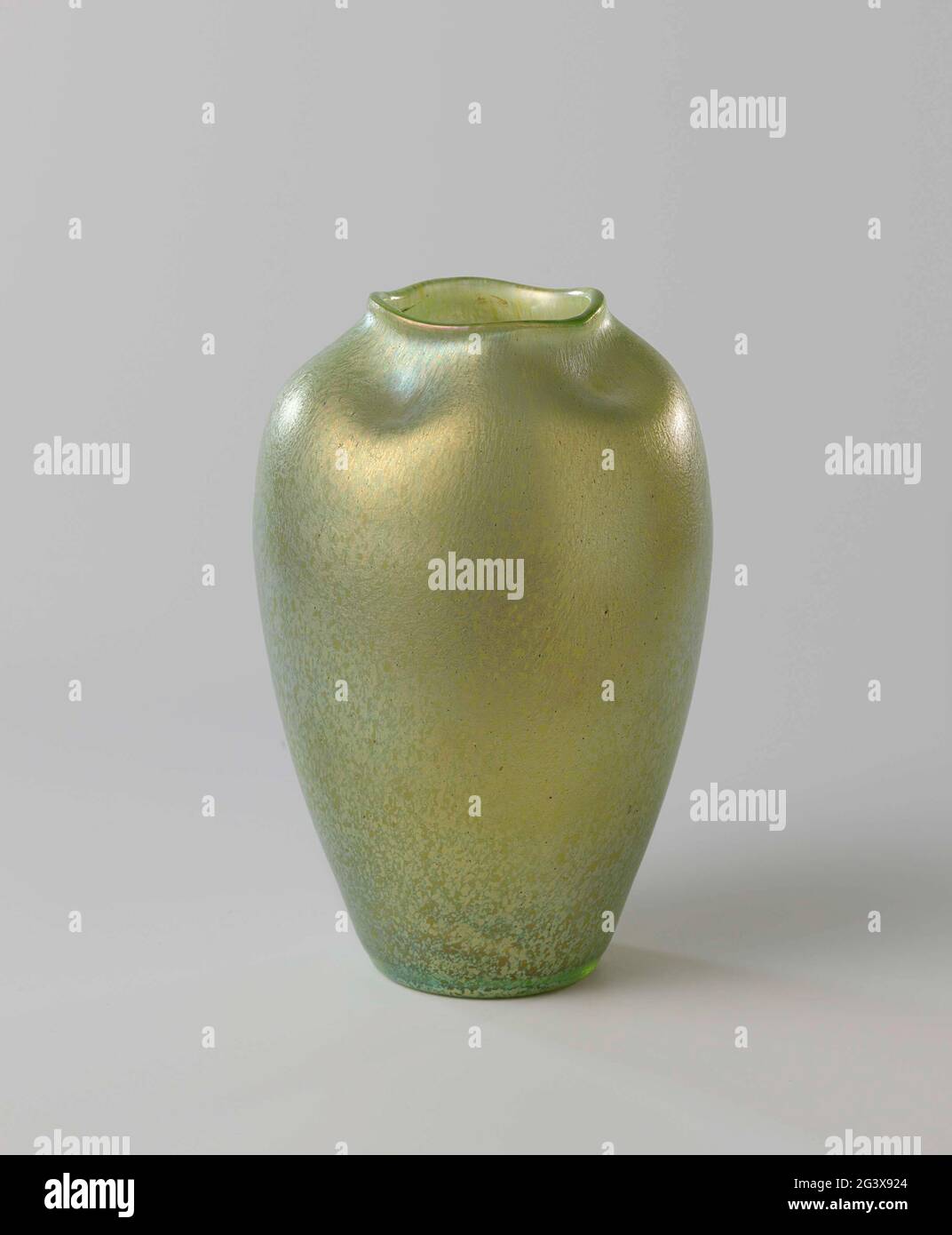 Vase with gusted green glass splinters and golden irisering. Flat soil ...