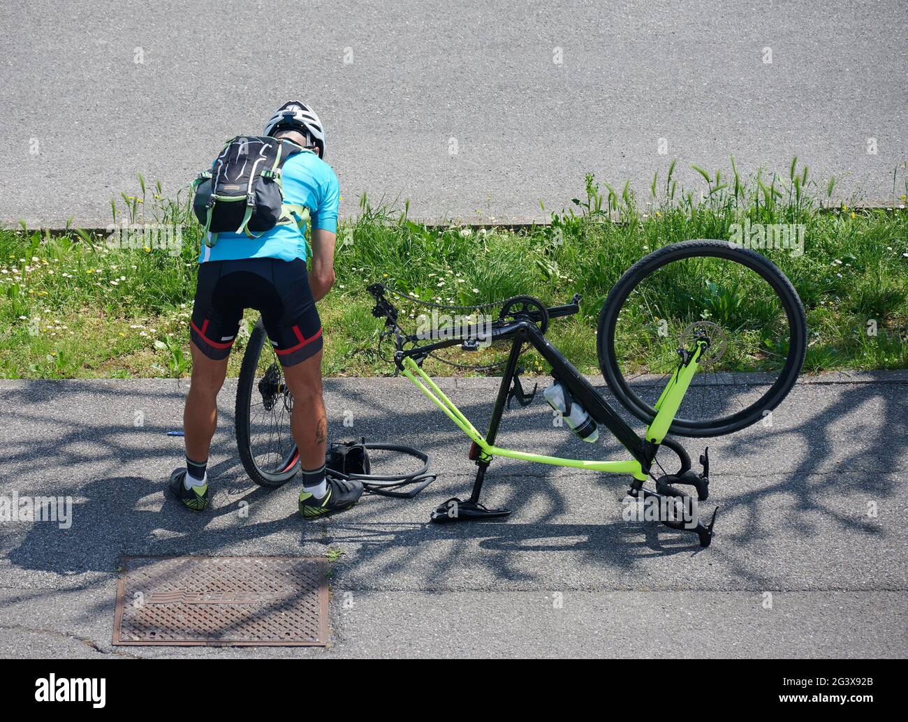 an amateur cyclist changes the inner tube to the bike wheel after a ...