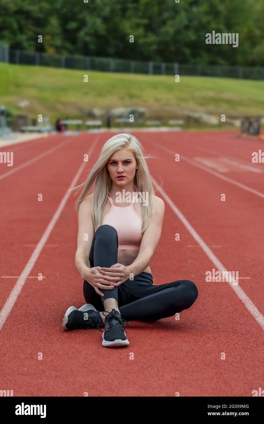 A Young Athletic College Athlete Prepares For A Track Meet At A ...