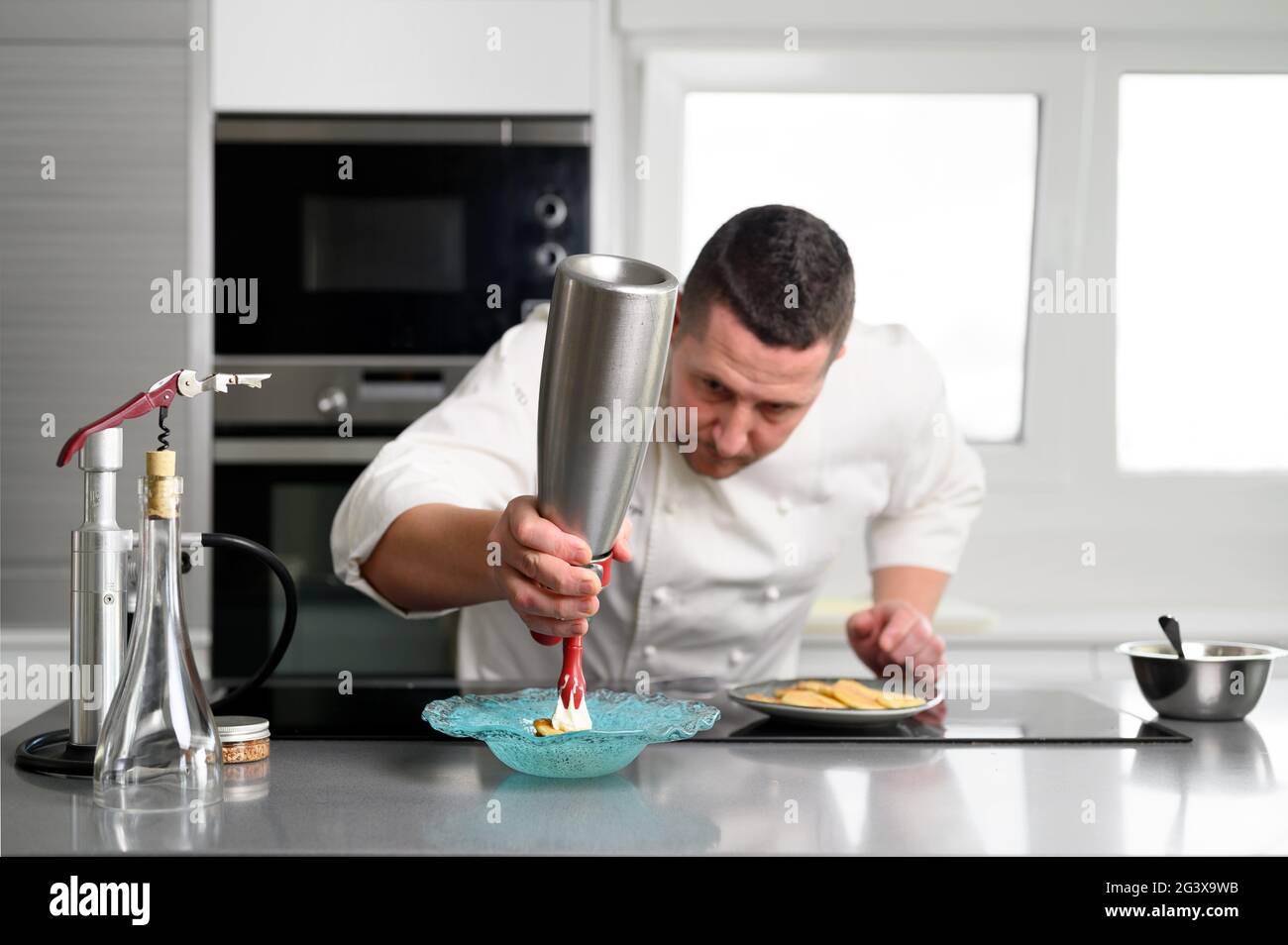 Professional chef holding a foam siphon in a restaurant kitchen Stock ...