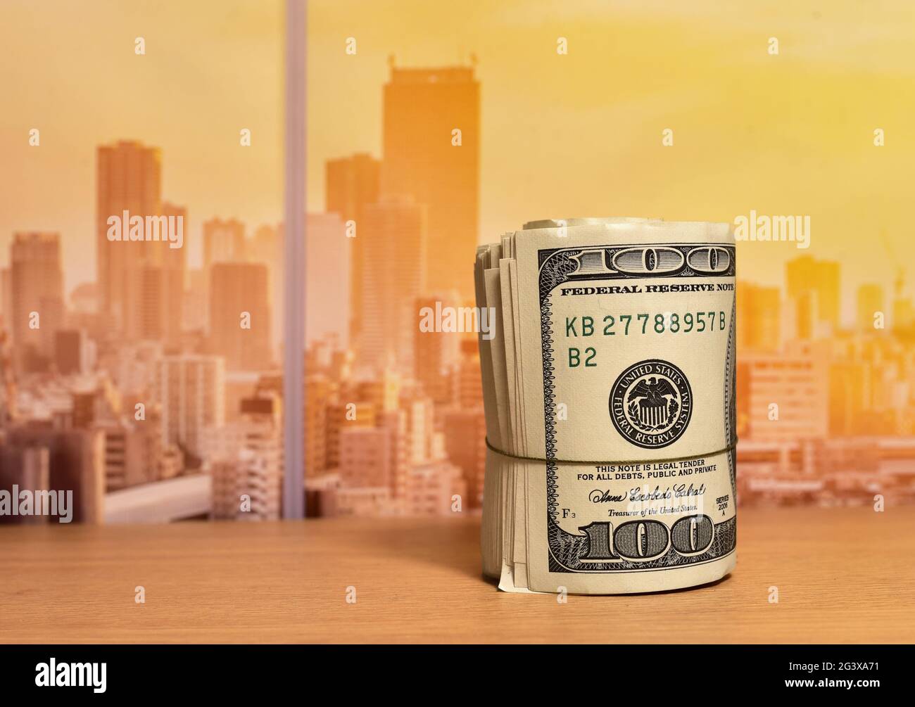 Money roll dollars on wooden table in office. Stack of money rolls 100 ...