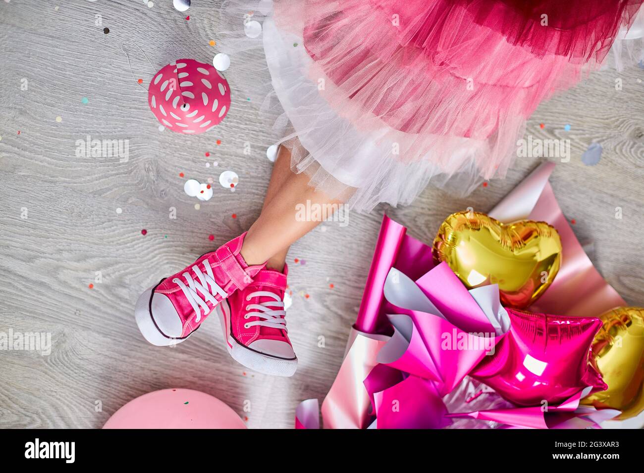 Creative lay out of funky leg of girl in pink sneakers and dress, flat ...