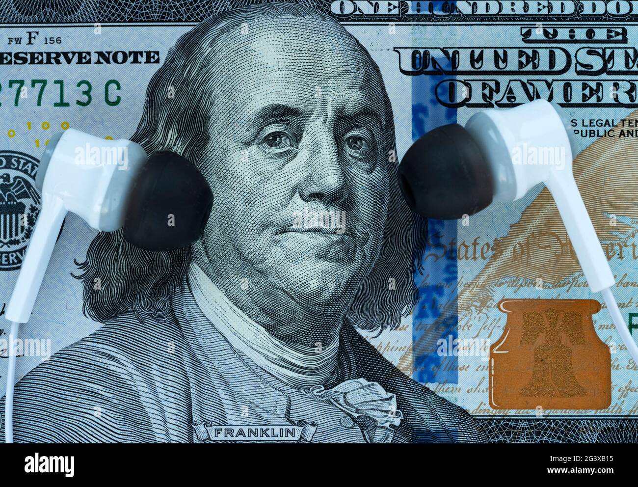 In this photo illustration earphones near Franklin's ears on a 100 ...