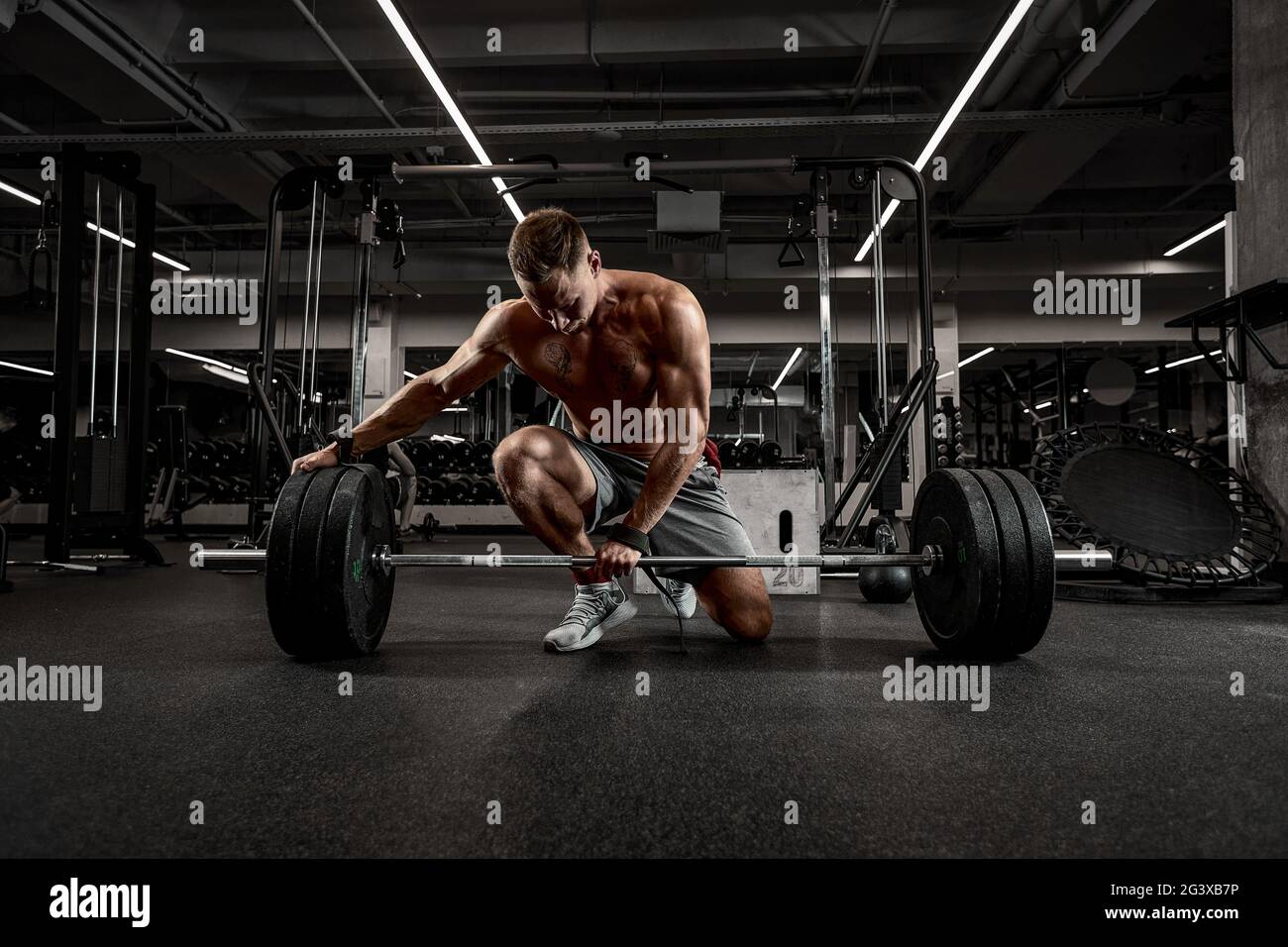 Athlete, bodybuilder exercise with a barbell, athlete prepares the ...