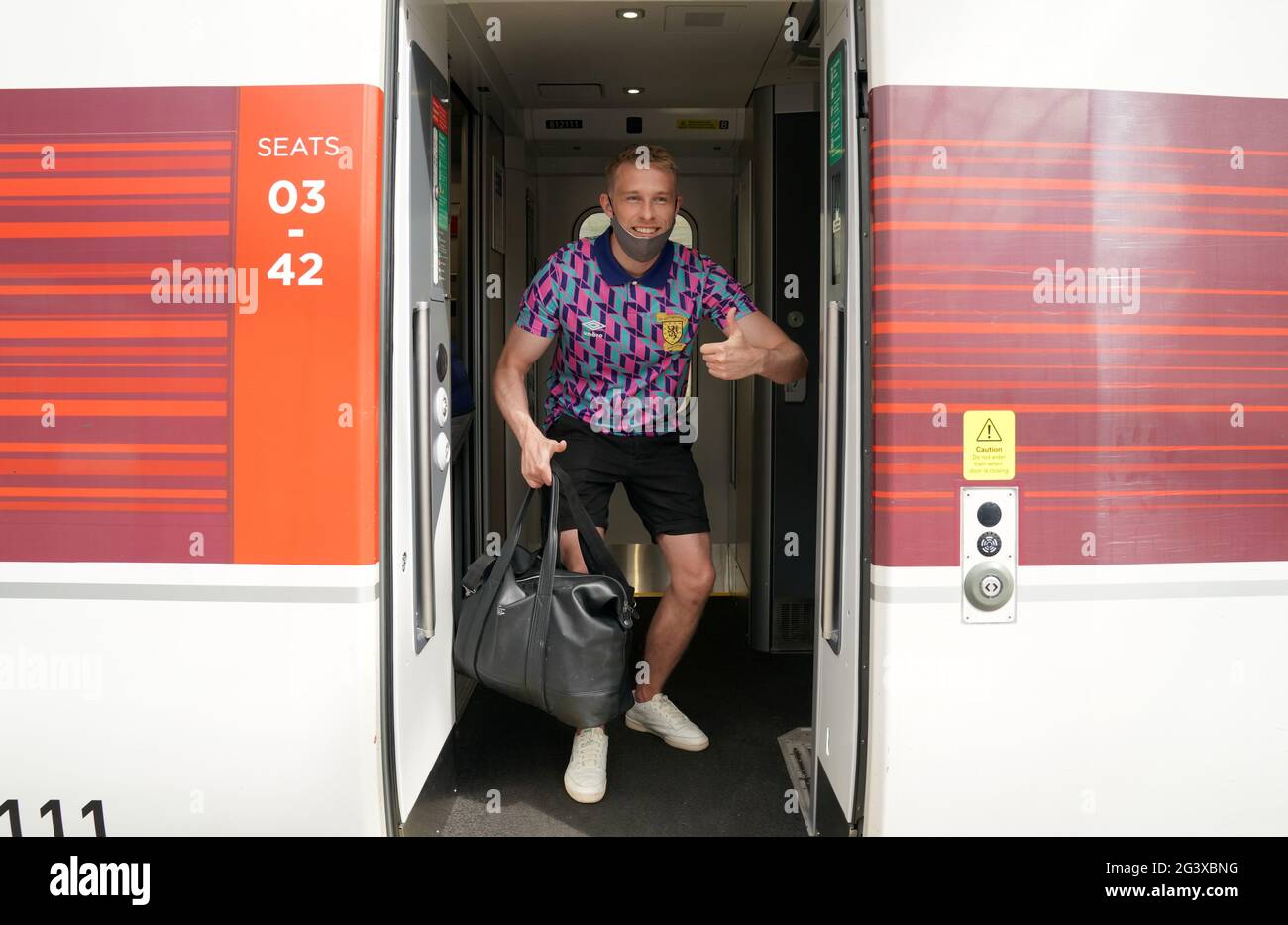 A Scotland fan boards a train at Edinburgh Waverley railway station as ...