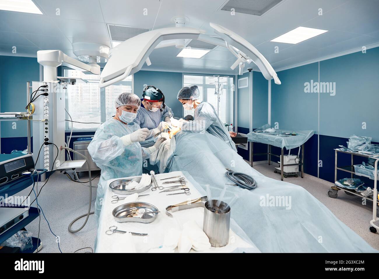 A modern operating room, surgeons and doctors doing an oncological ...
