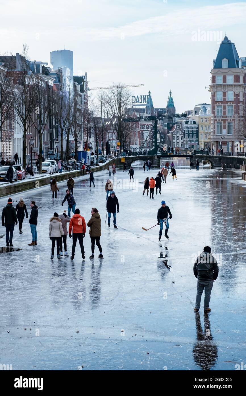 Ice skating on the canals in Amsterdam the Netherlands in winter ...