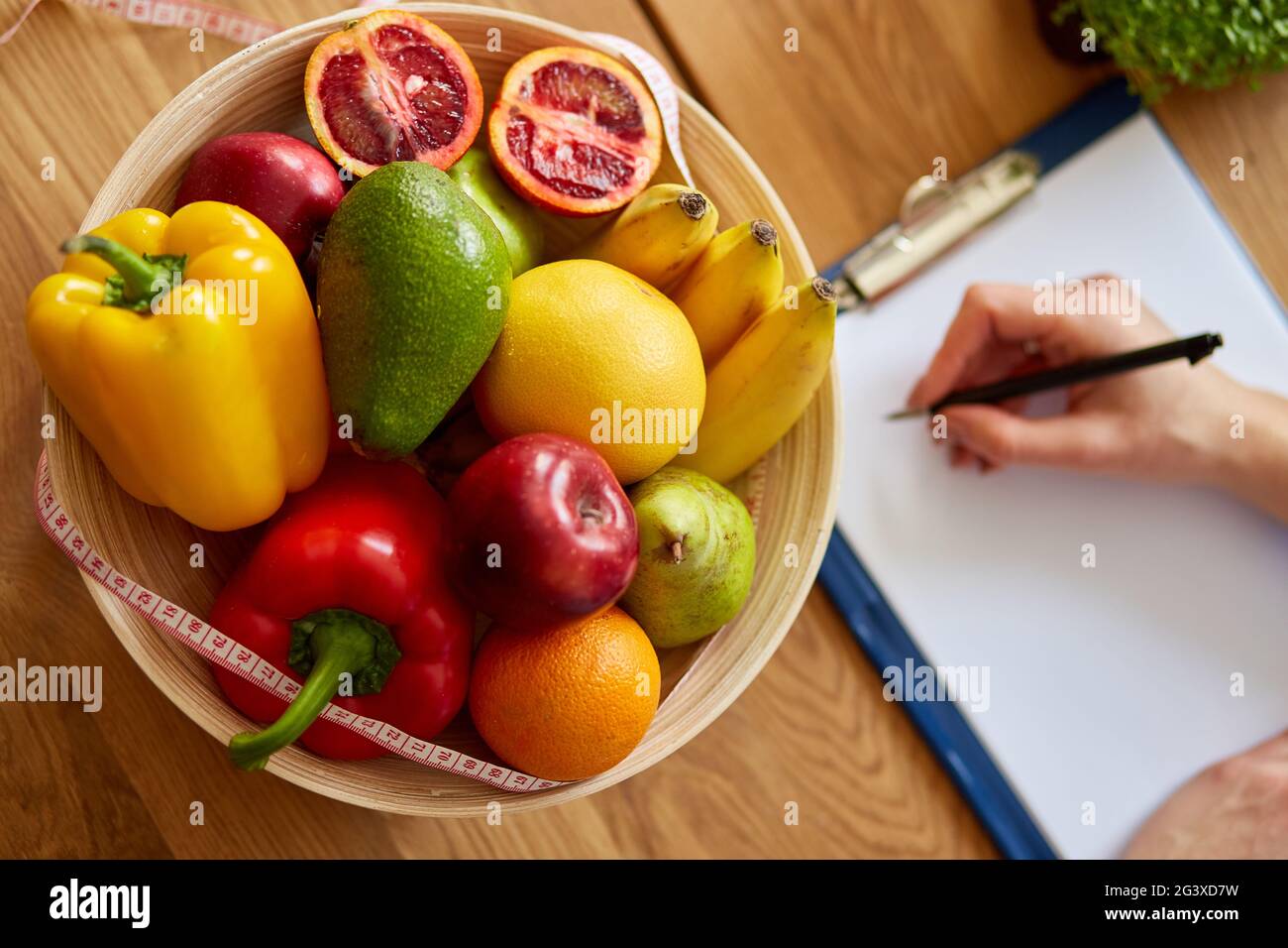 Nutritionist, dietitian woman writing a diet plan, with healthy ...