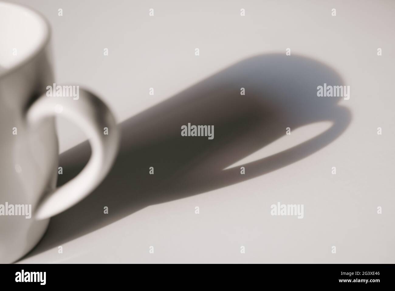 Coffee cup with long shadow cream color side view. Focus on shadow ...