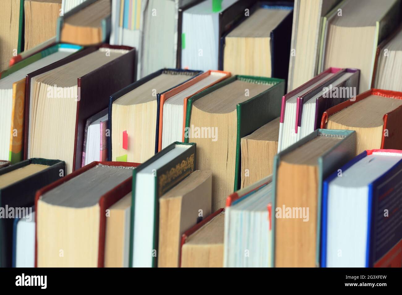 This is a lot of books standing together in several rows. Solid ...