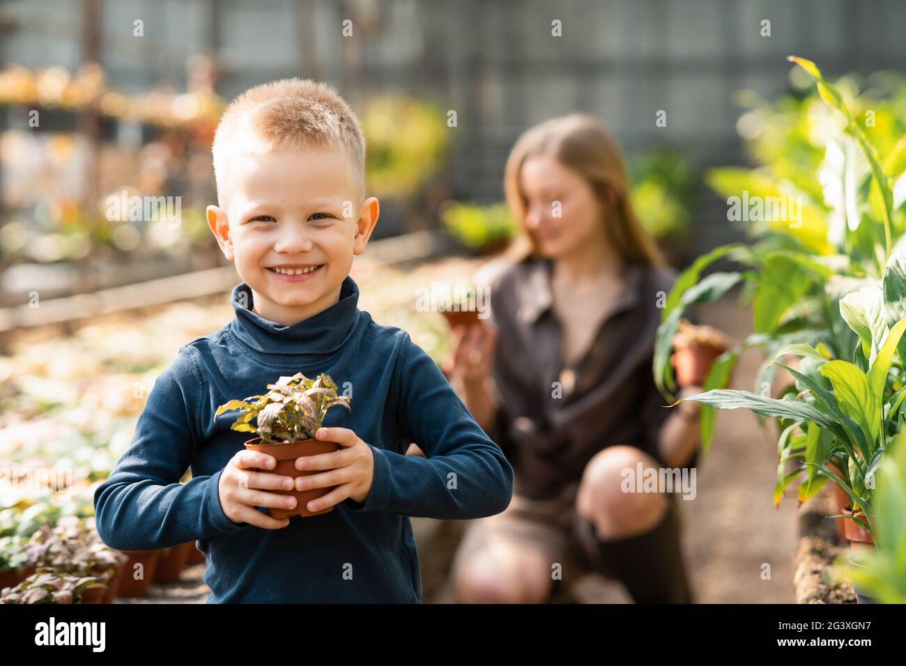 Boy plant pot hi-res stock photography and images - Alamy