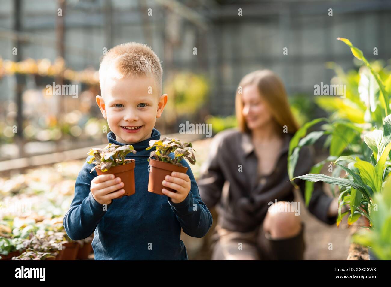 Cheerful boy holding pots hi-res stock photography and images - Alamy