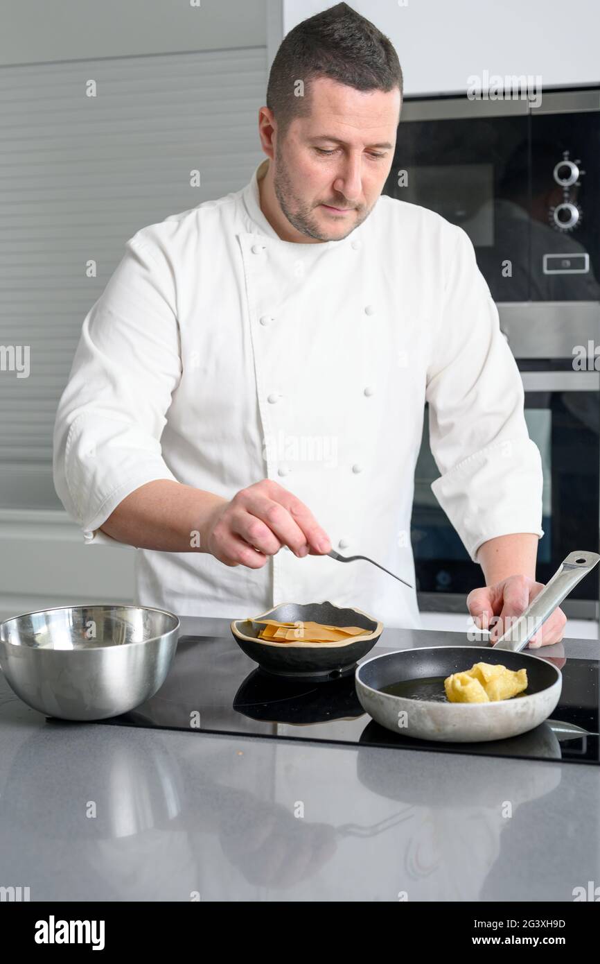 Male chef cooking on frying pan Stock Photo - Alamy