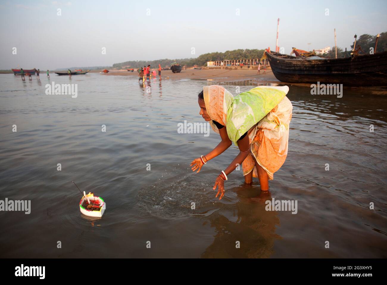 Devotee sailing model boat in the sea on the occasion of 'Boitha ...