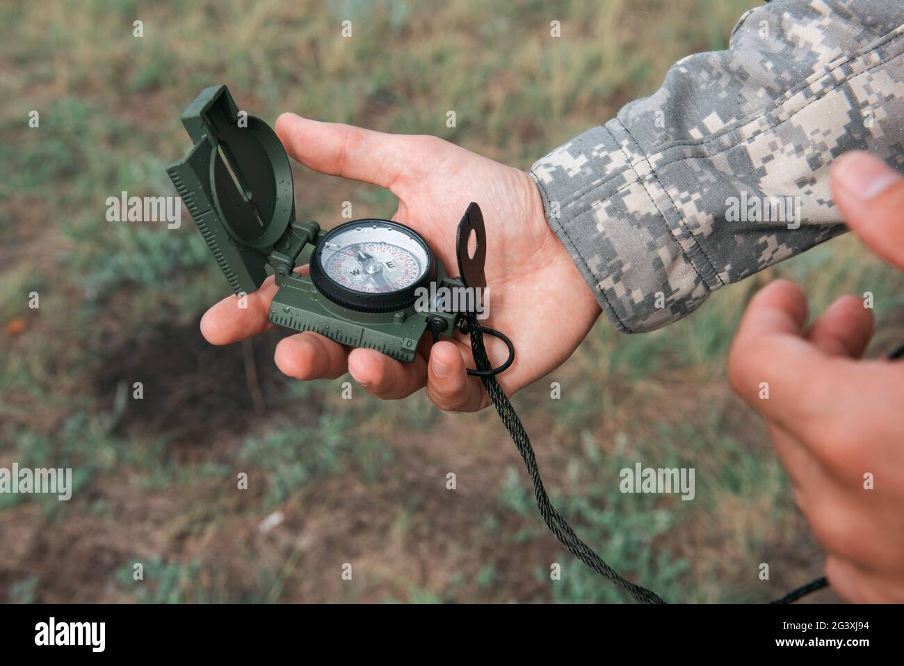 Man with compass in hand outdoor Stock Photo - Alamy