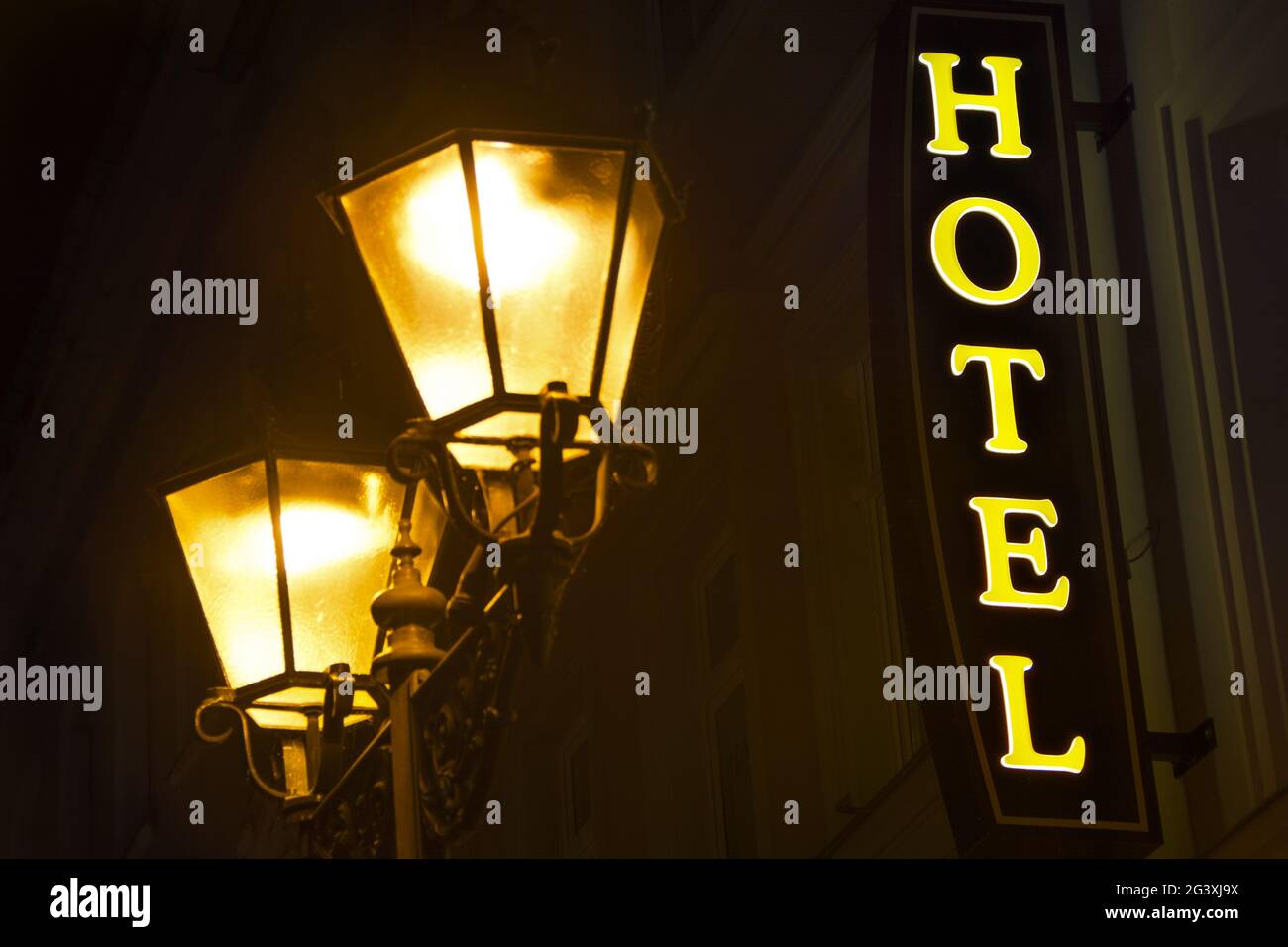 Illuminated sign HOTEL & street light at night Stock Photo - Alamy