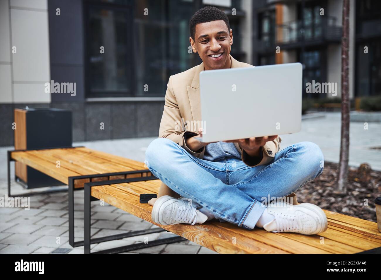 Young brunette male staring at screen of his laptop Stock Photo - Alamy