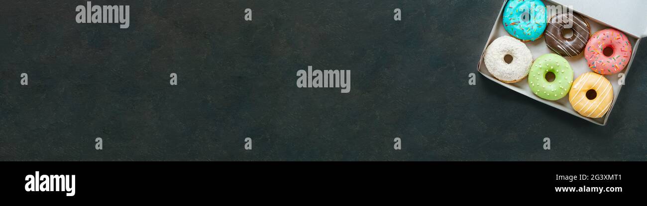 Glazed donuts in paper box, top view, copy space Stock Photo - Alamy