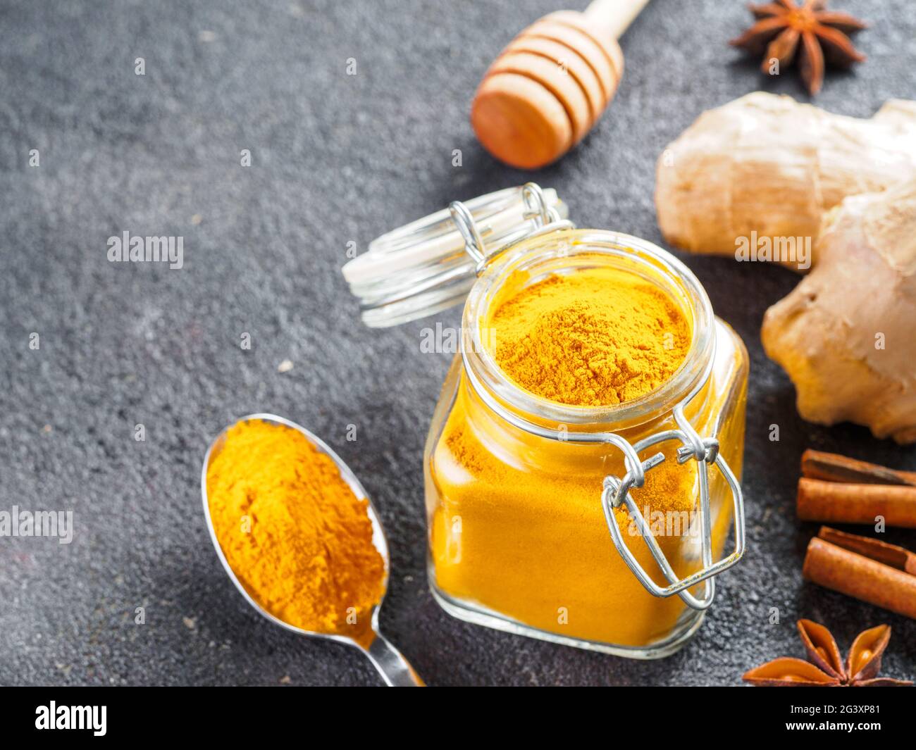 Turmeric powder in glass jar and spoon Stock Photo - Alamy